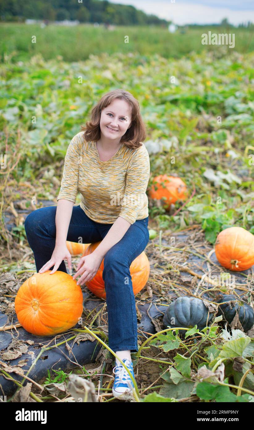 Girl having fun on the pumpkin patch Stock Photo - Alamy