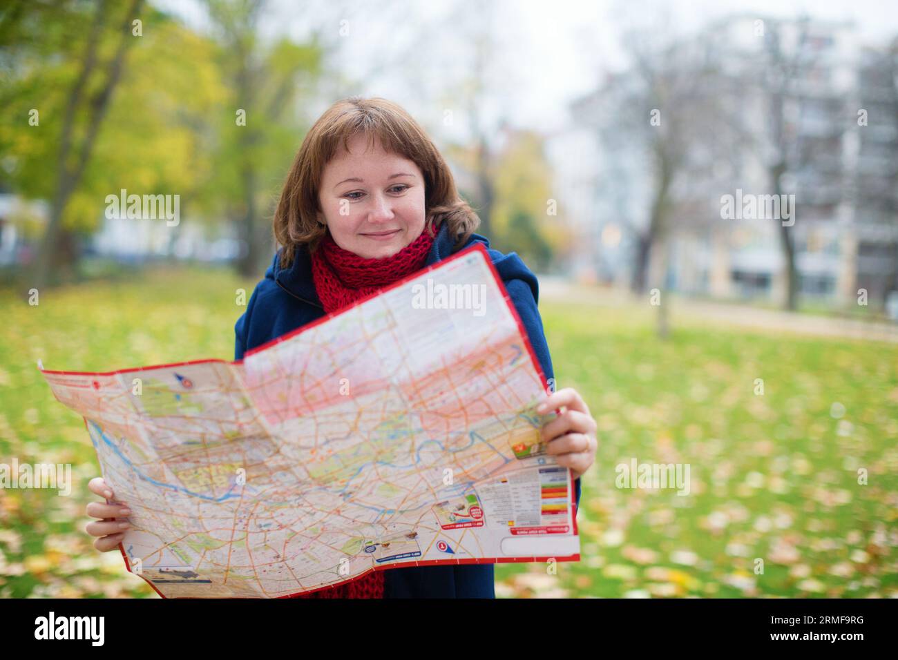 Girl with a map on the street Stock Photo - Alamy