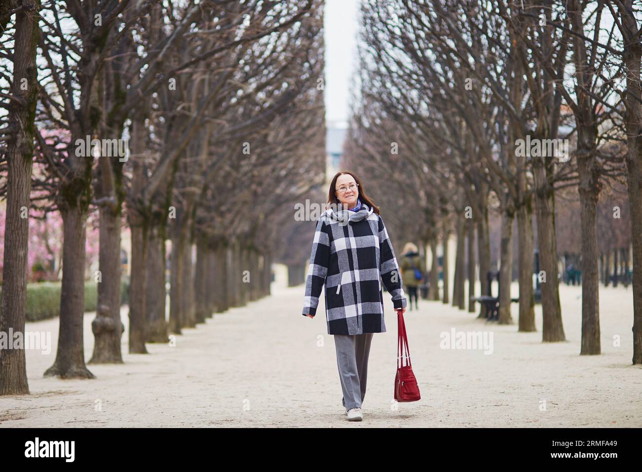 Middle aged woman walking in Paris, France Stock Photo - Alamy
