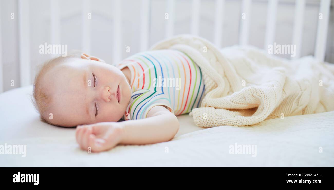 Newborn Baby Girl Sleeping In Crib