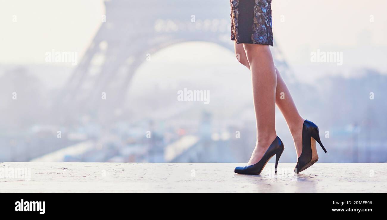 Woman wearing high heels shoes and walking near the Eiffel tower at ...