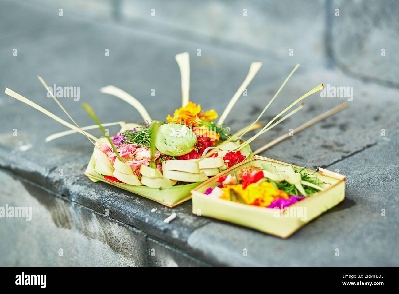 Traditional Balinese offerings to gods with flowers and aromatic sticks ...