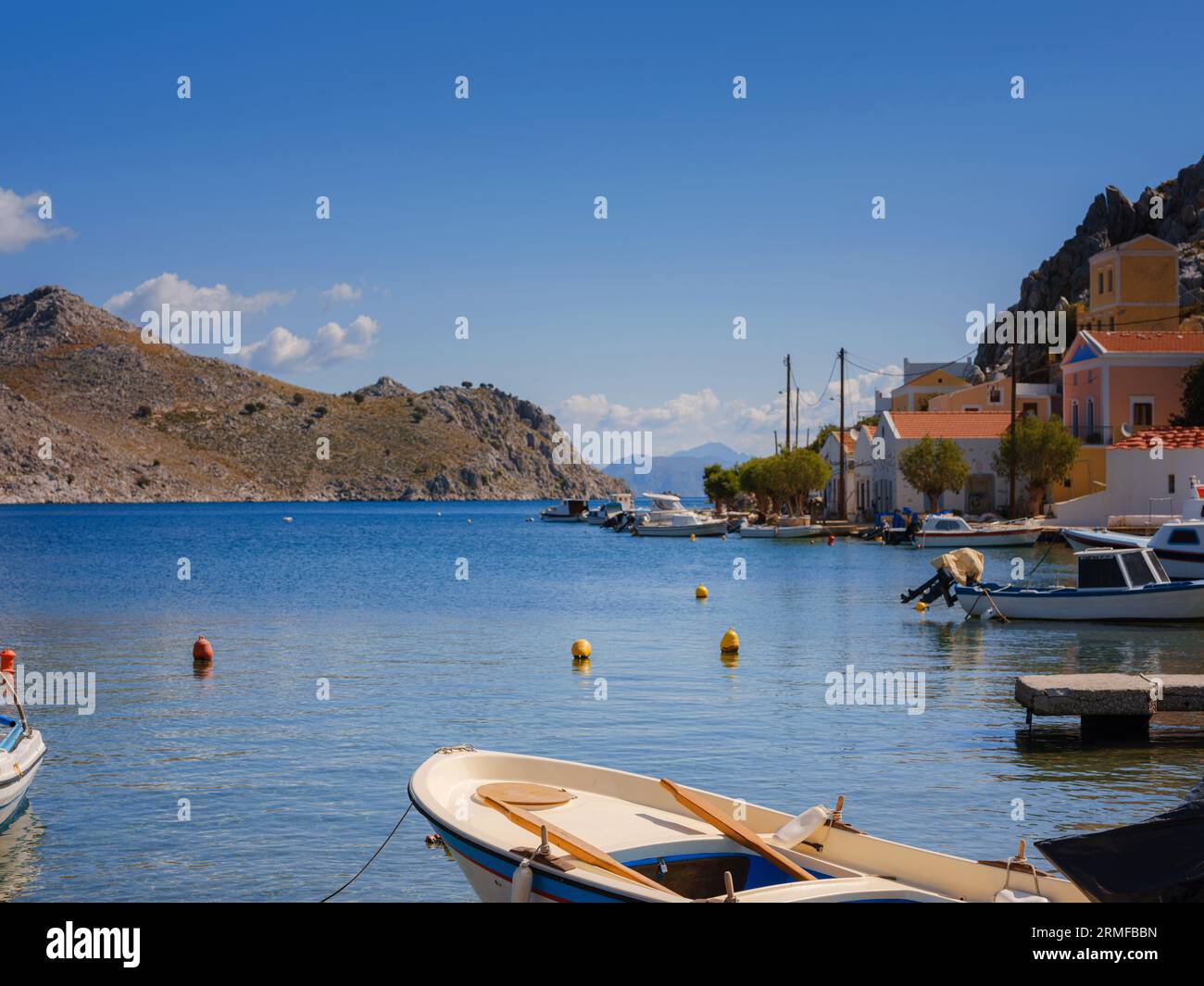 View on Symi or Simi island harbor port, classical ship yachts, houses ...