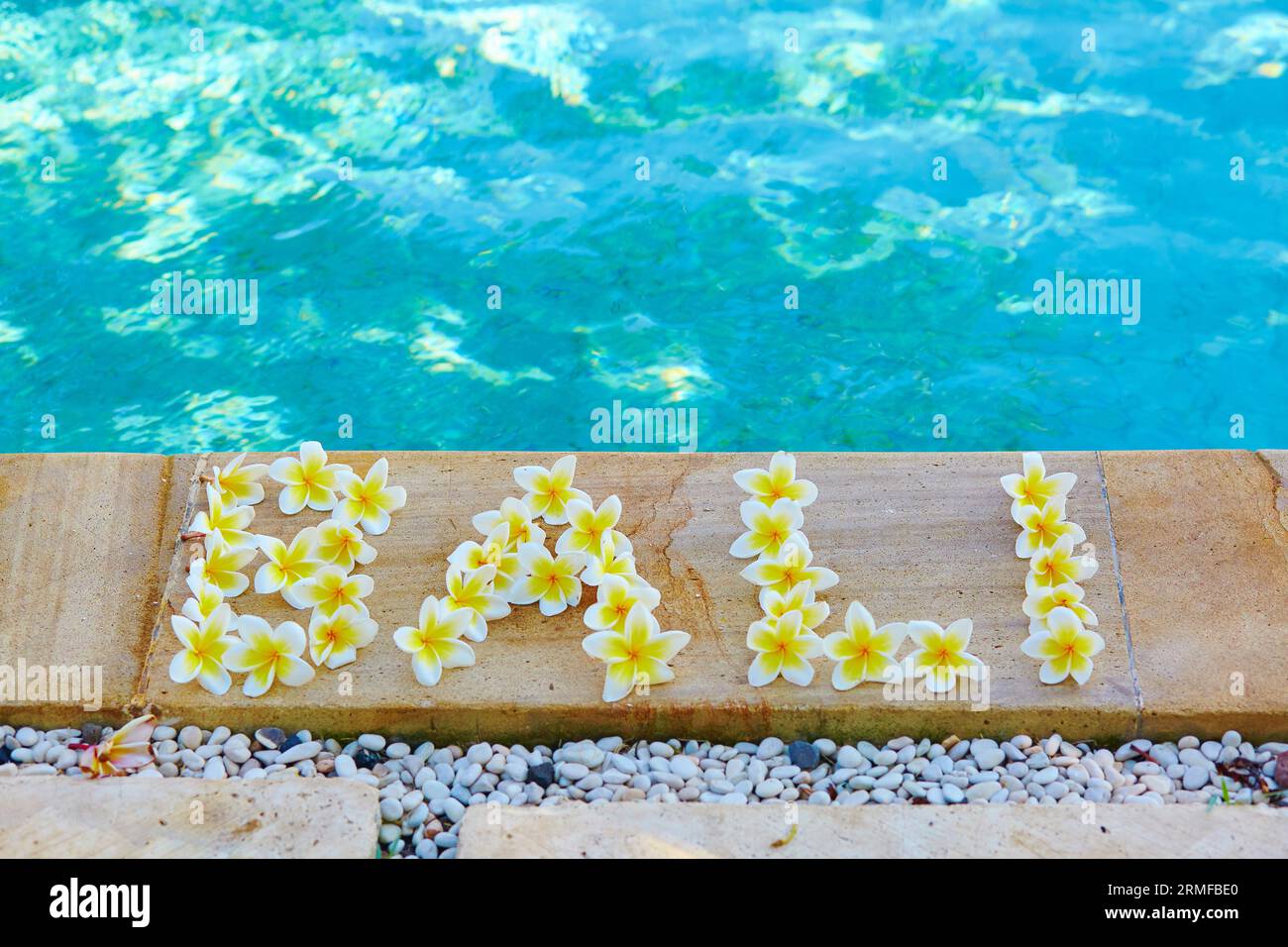 Word Bali written with frangipani flowers near the pool Stock Photo - Alamy