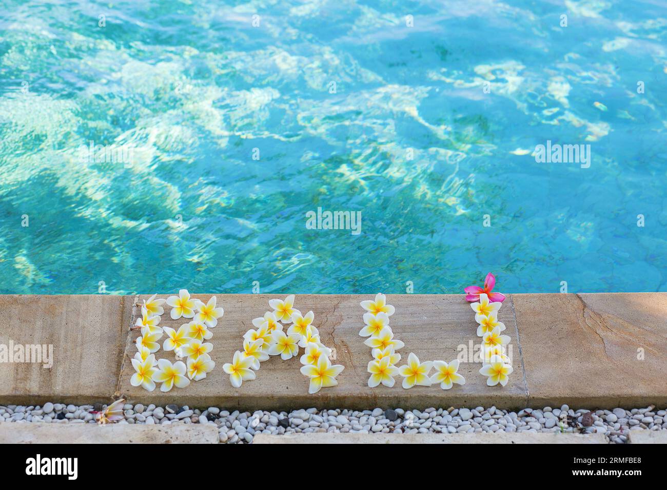 Word Bali written with frangipani flowers near the pool Stock Photo - Alamy