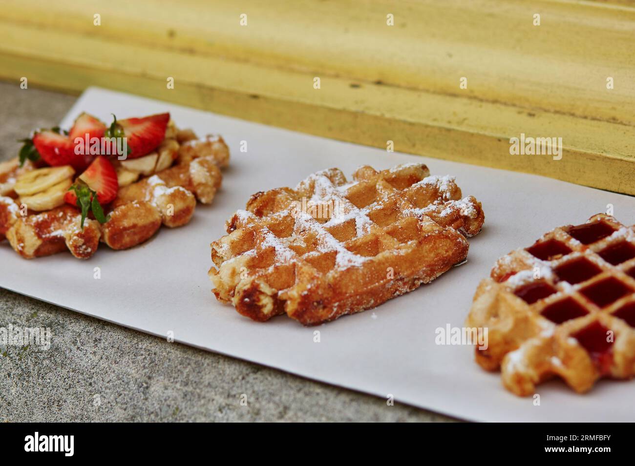 Typical belgian waffle in the street, ready to eat Stock Photo - Alamy