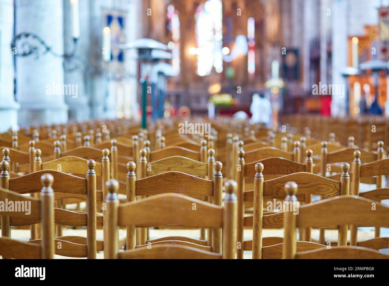 Many wooden chairs in a church Stock Photo - Alamy