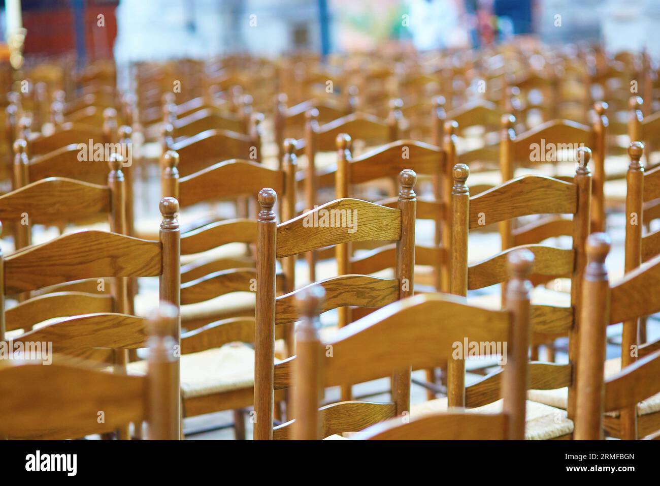 Many wooden chairs in a church Stock Photo - Alamy