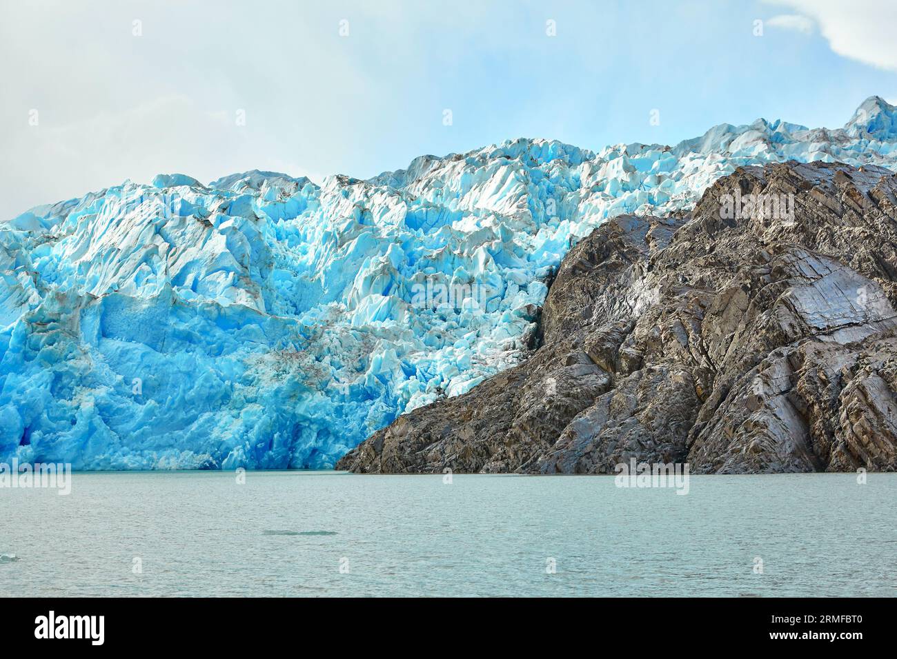Blue icebergs and snowy mountains at Grey Glacier in Torres del Paine ...