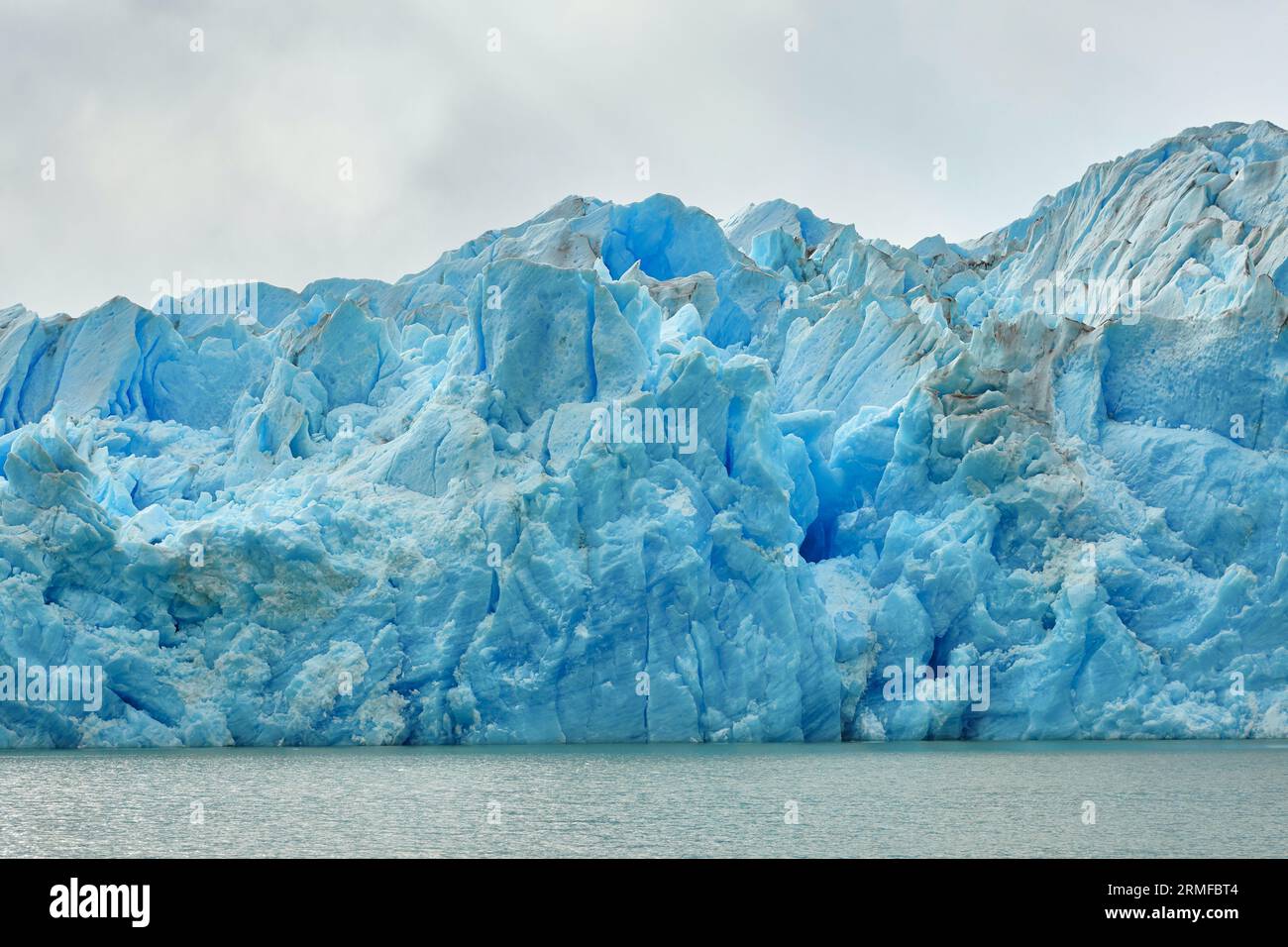 Blue icebergs and snowy mountains at Grey Glacier in Torres del Paine ...