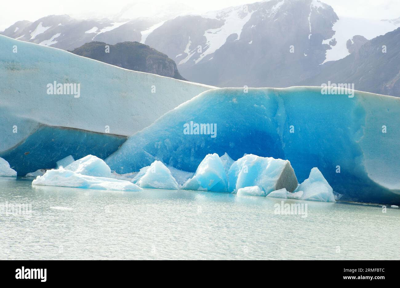 Blue icebergs and snowy mountains at Grey Glacier in Torres del Paine ...