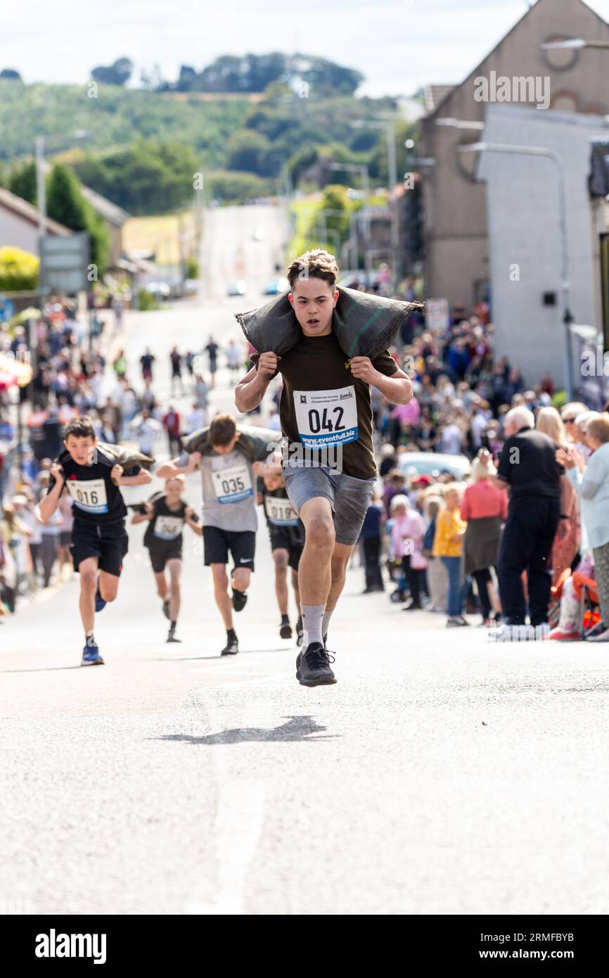 Boys taking part in the Scottish Coal Carrying Championships through ...