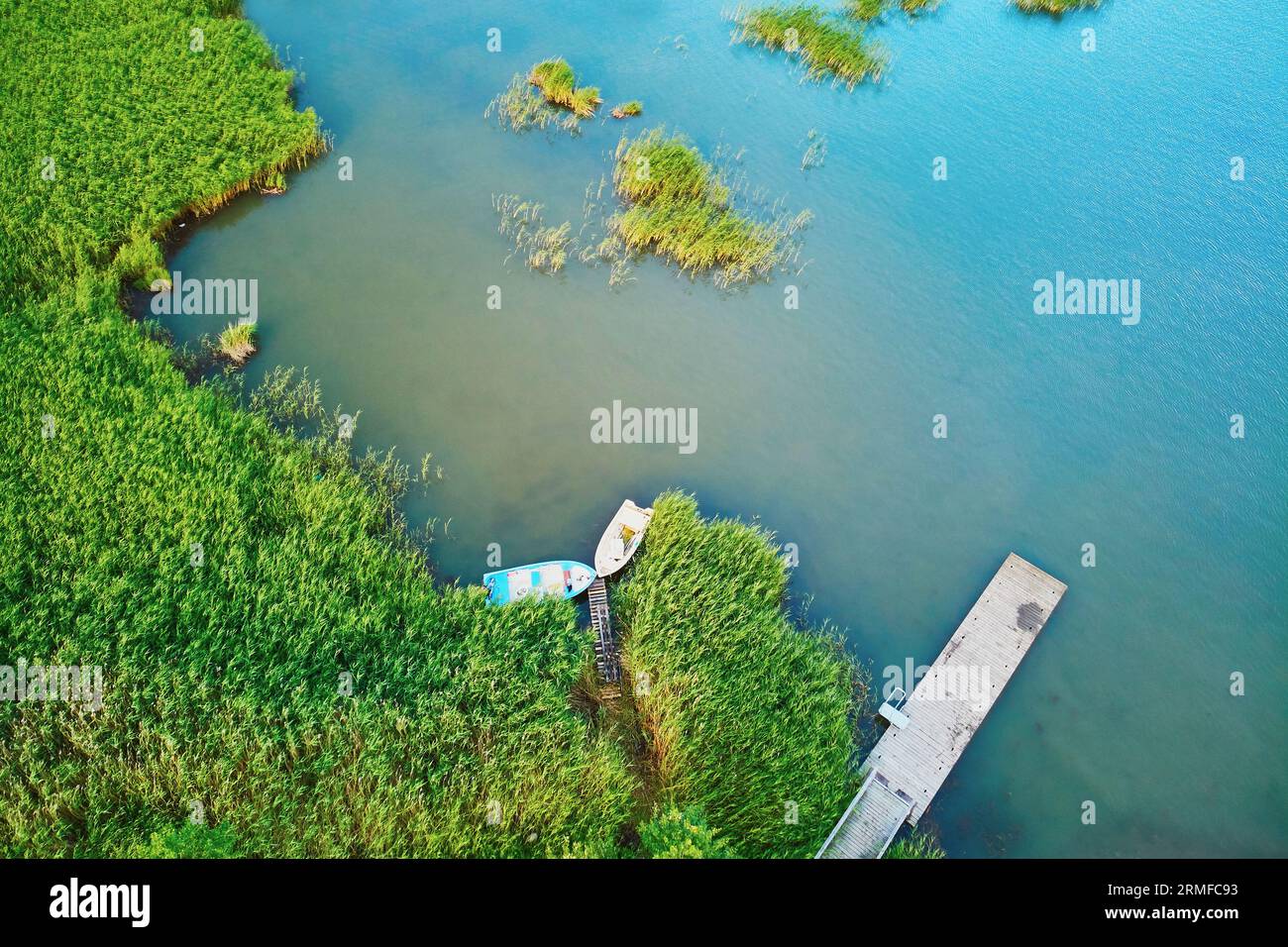 Scenic top down view of colorful boats near wooden berth in the ...