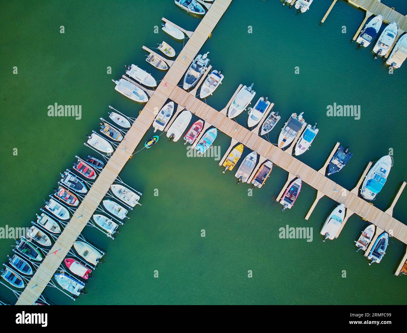 Scenic top down view of colorful boats near wooden berth in the ...