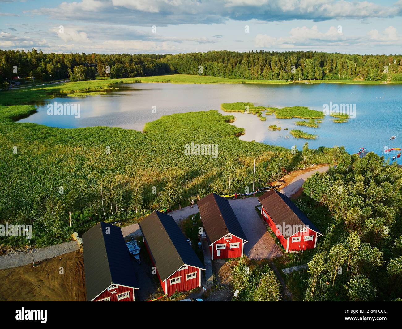 Scenic aerial view of colorful boats near wooden berth and buildings in ...
