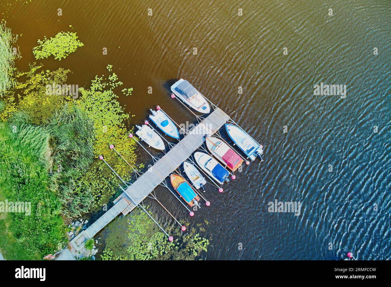 Scenic top down view of colorful boats near wooden berth in the ...
