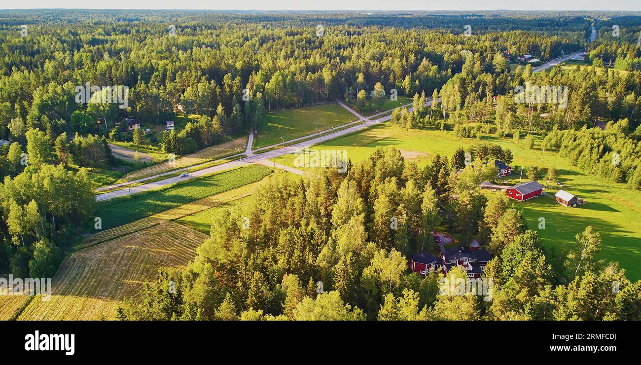 Aerial view of road surrounded by forest in typical countryside of ...