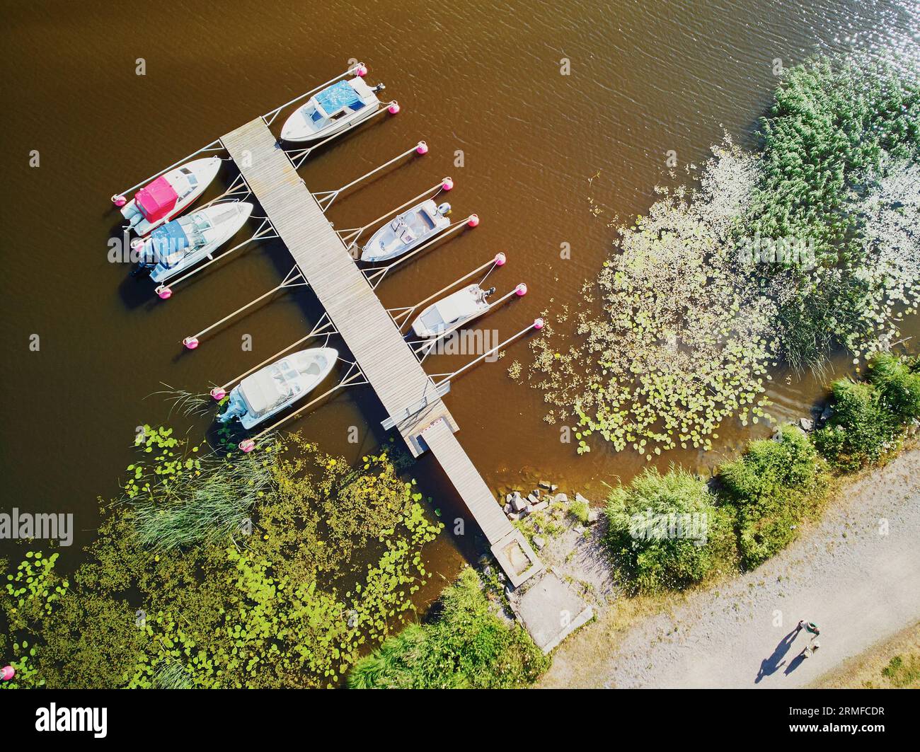 Scenic top down view of colorful boats near wooden berth in the ...