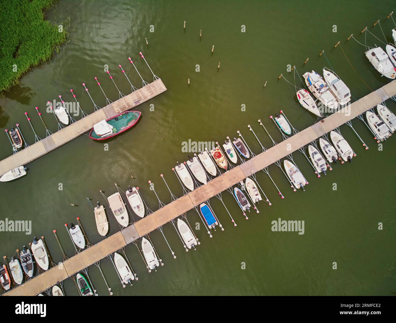 Scenic top down view of colorful boats near wooden berth in the ...