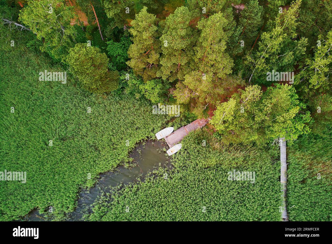 Scenic top down view of colorful boats near wooden berth in the ...