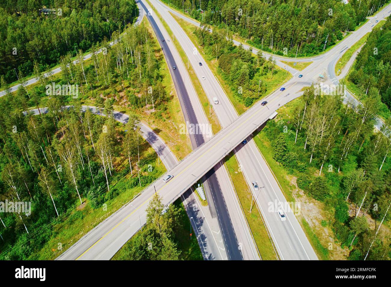 Aerial view of road interchange surrounded by forest in the countryside ...