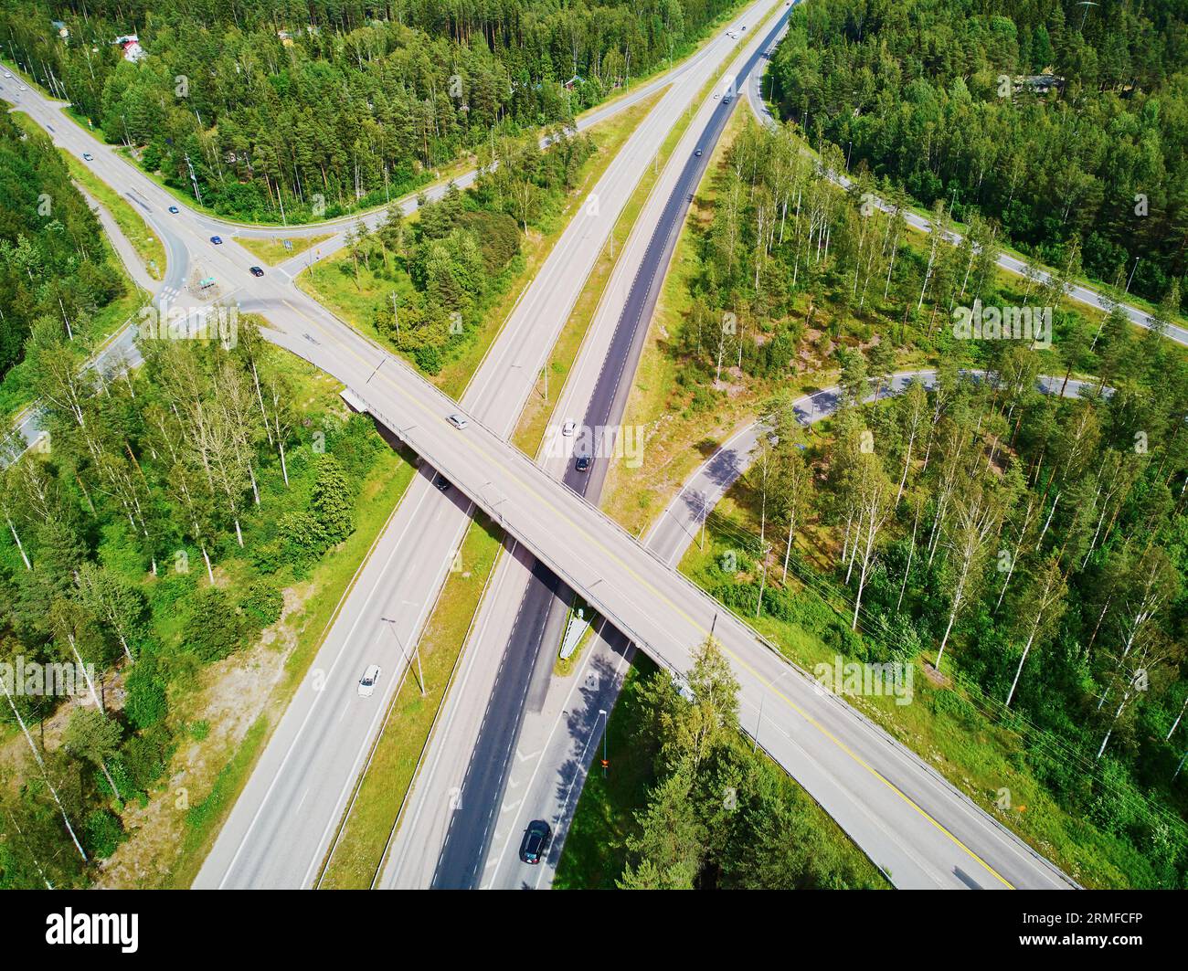 Aerial view of road interchange surrounded by forest in the countryside ...