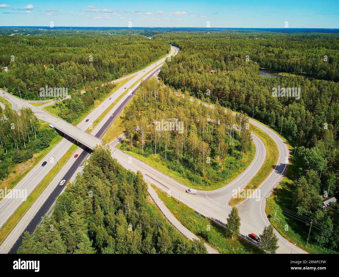 Aerial view of road interchange surrounded by forest in the countryside ...