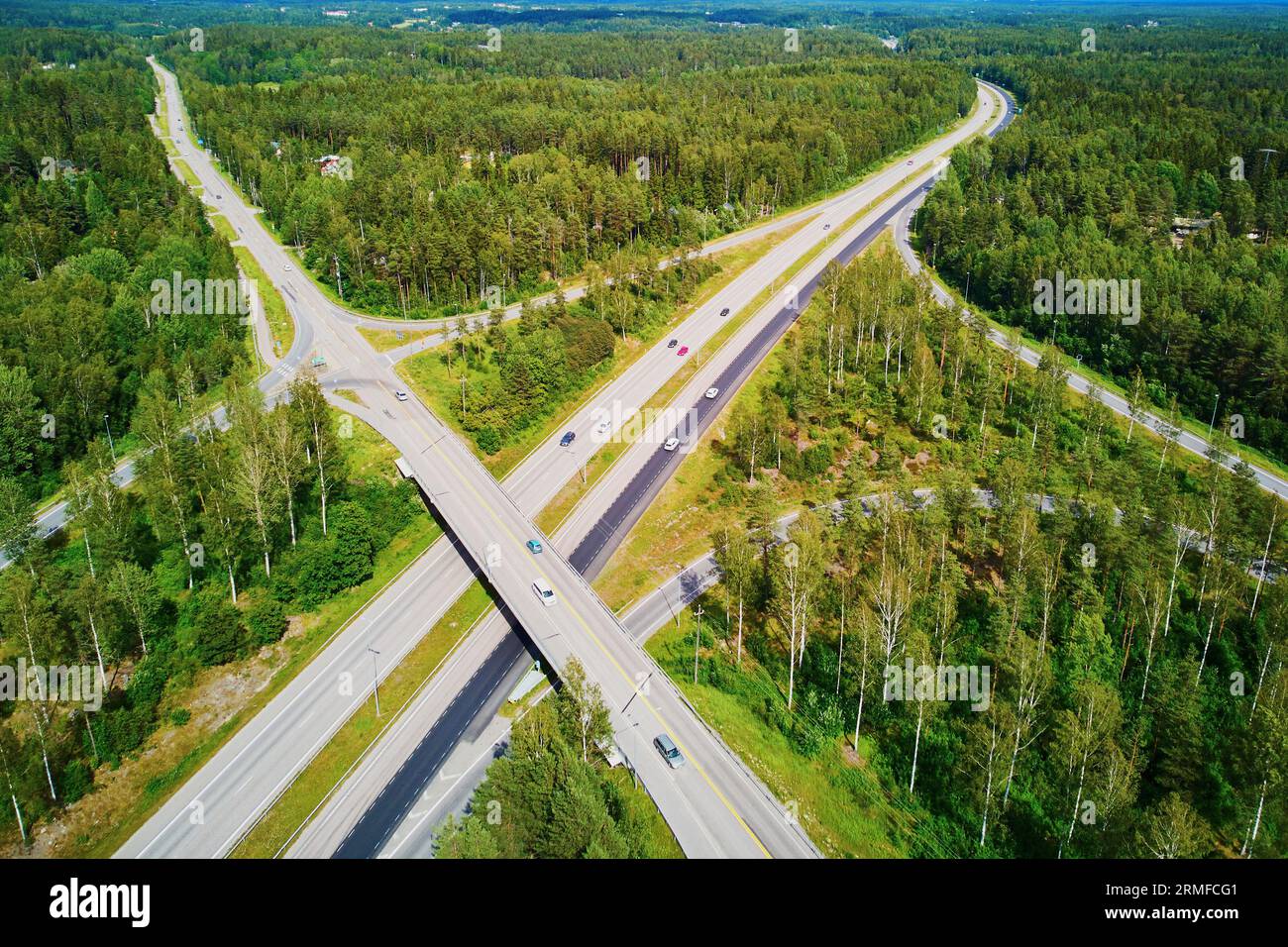 Aerial view of road interchange surrounded by forest in the countryside ...