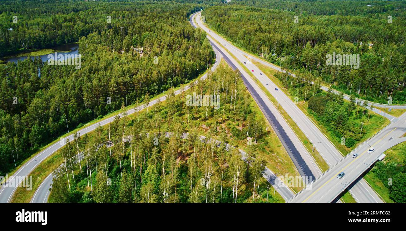 Aerial view of road interchange surrounded by forest in the countryside ...