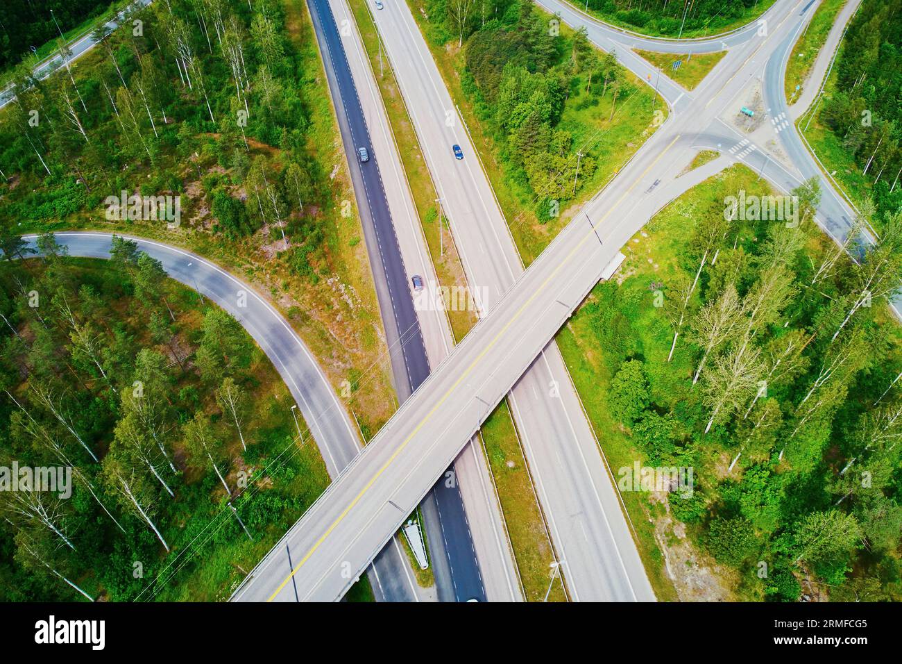 Aerial view of road interchange surrounded by forest in the countryside ...