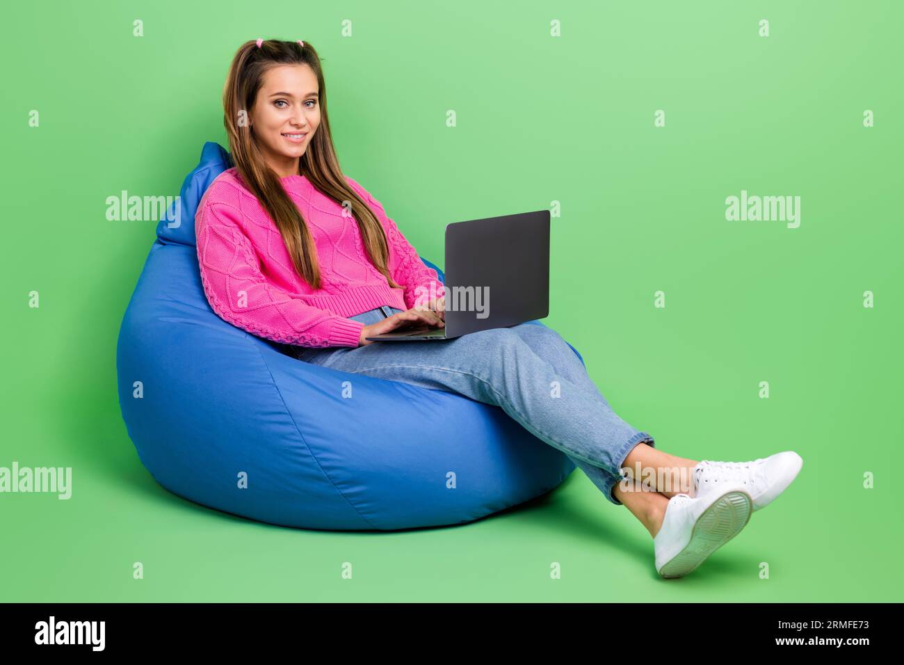 Full length photo of clever woman with tails dressed pink sweater sit ...