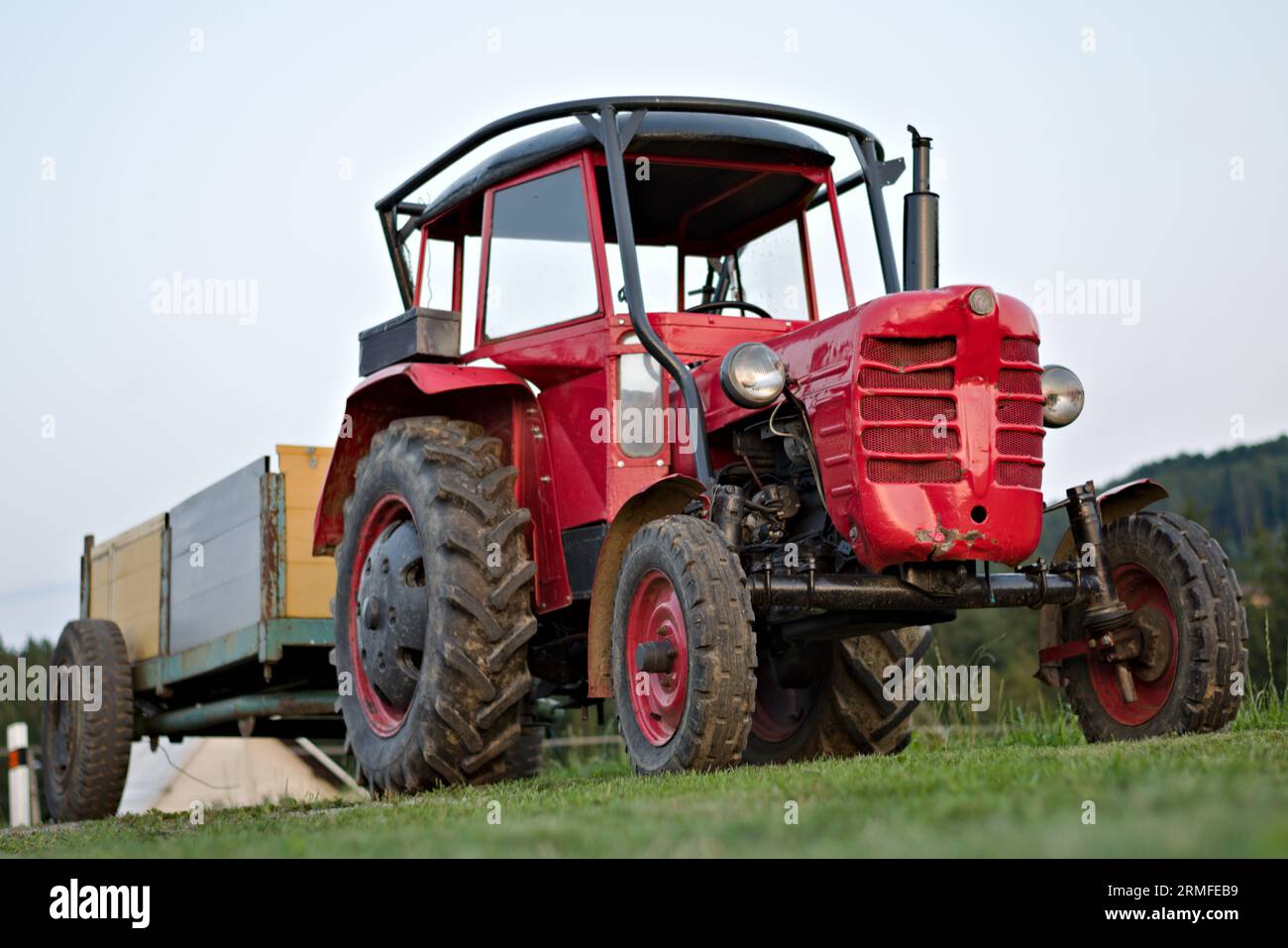 Vintage red czech tractor Zetor with trailer on small village farm ...