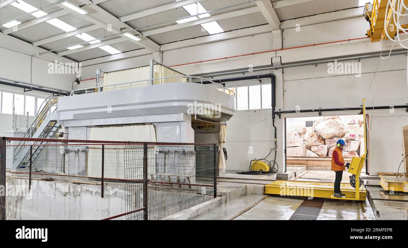 man in stone cutting factory/workshop. stone mine. marble mine ...