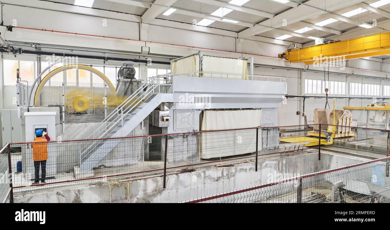 man in stone cutting factory/workshop. stone mine. marble mine ...