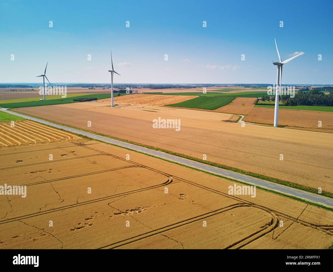 Scenic aerial drone view of wind trubines and green and yellow fields ...