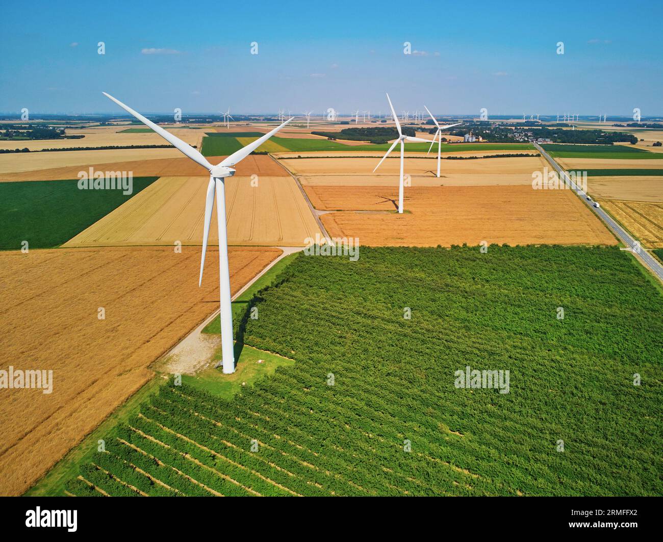 Scenic aerial drone view of wind trubines and green and yellow fields ...