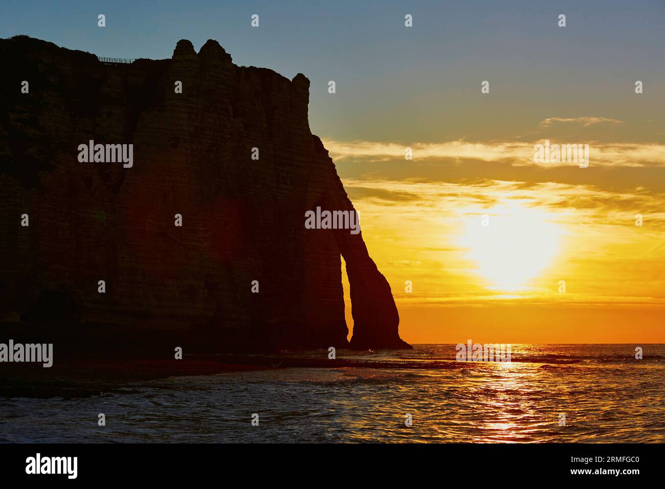 Scenic view of Etretat with its beach and famous cliffs with arches at ...