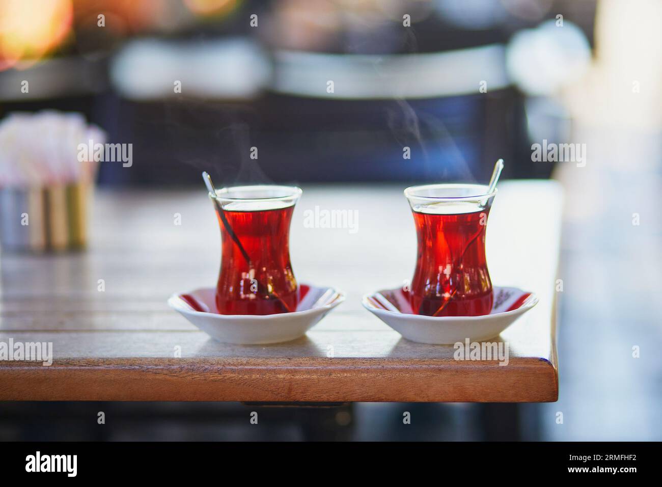 Traditional Turkish tea served in tulip shaped glasses in cafe or ...
