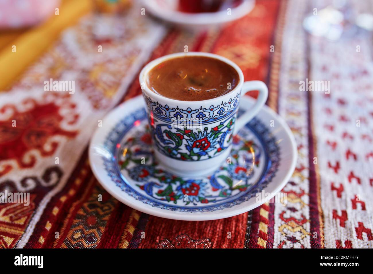 Traditional Turkish coffee served served in colorful decorated cup in ...