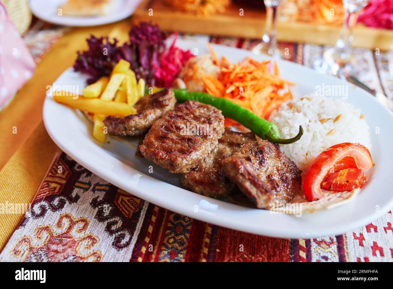 Delicious Turkish kofta served with rice and vegetables in a restaurant ...