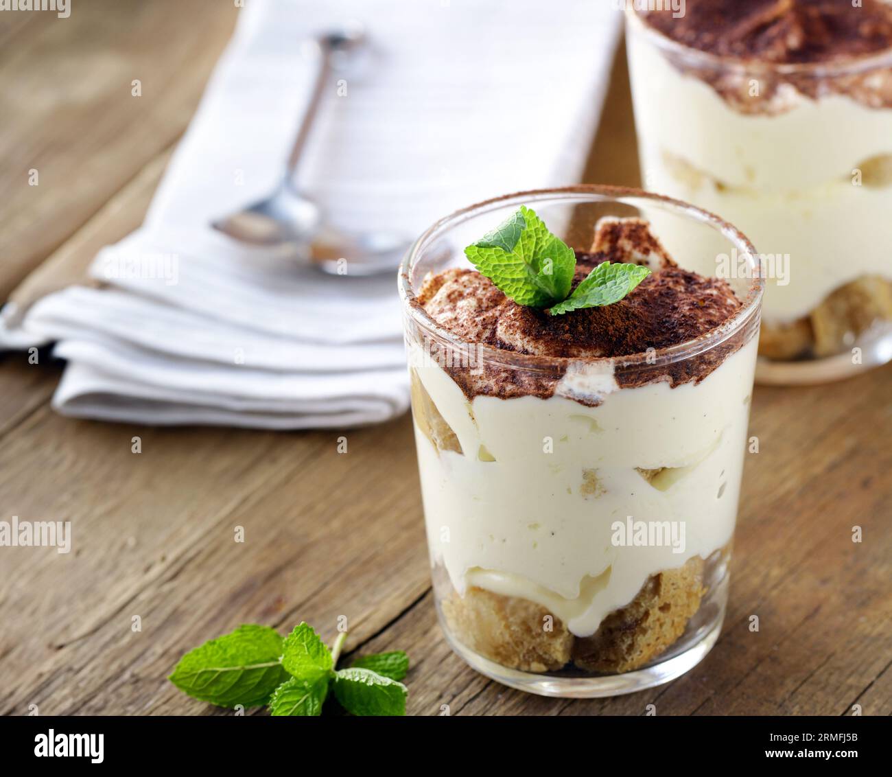 dessert tiramisu in a glass portion serving Stock Photo - Alamy