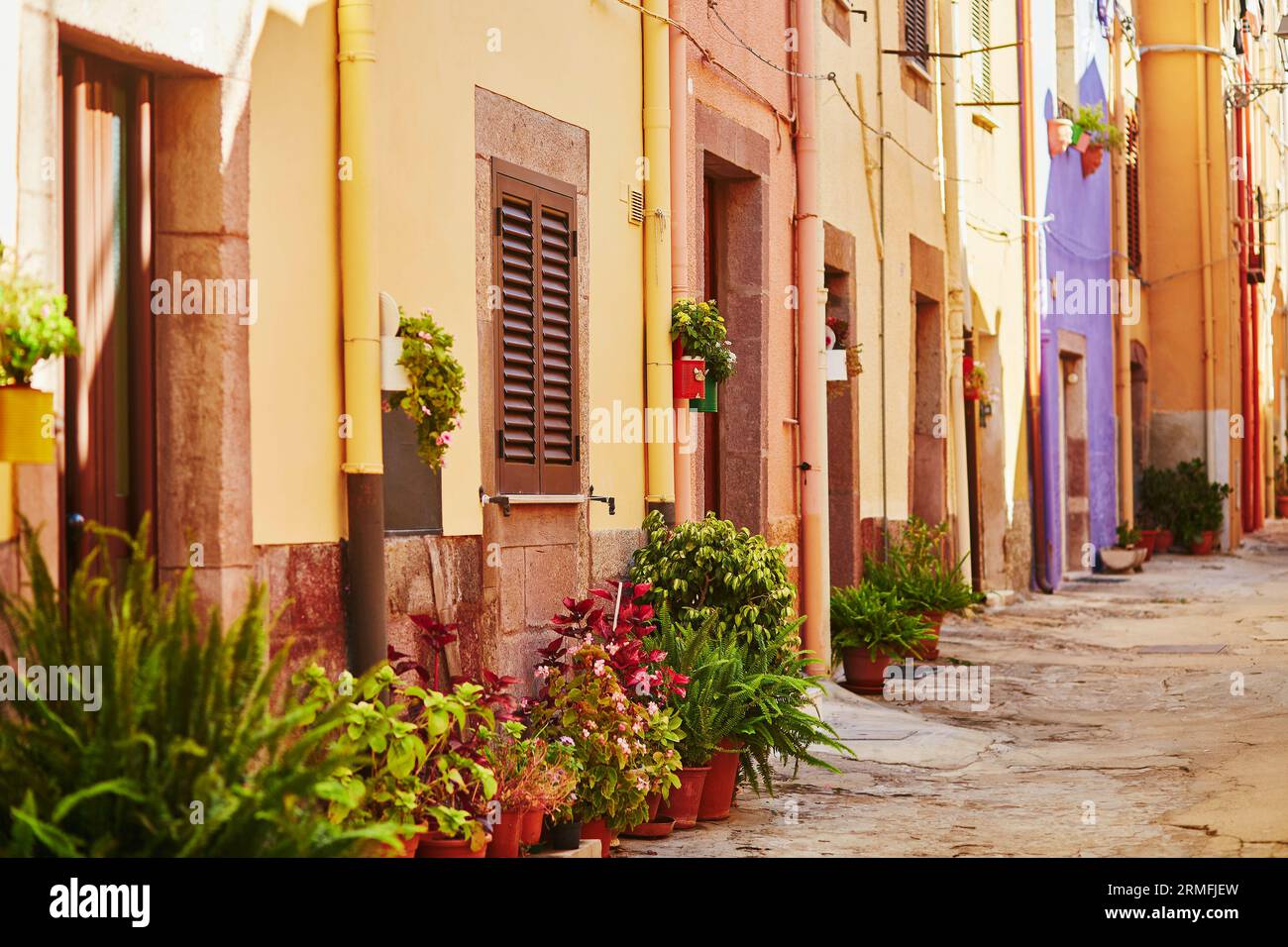 Typical colorful Italian houses on a street of Bosa, Sardinia, Italy ...
