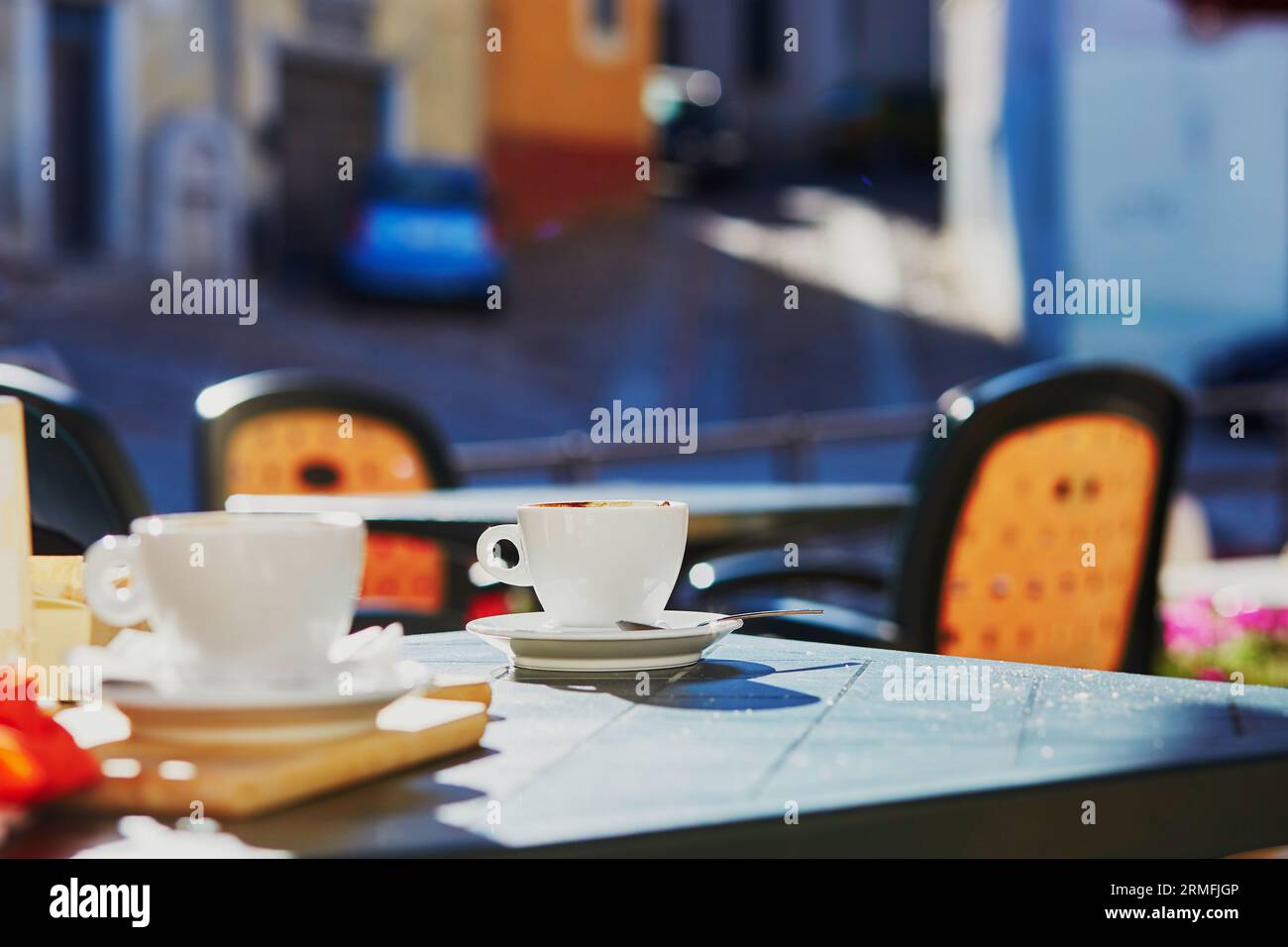 Coffee cups on table of cafe or restaurant of small typical village in ...