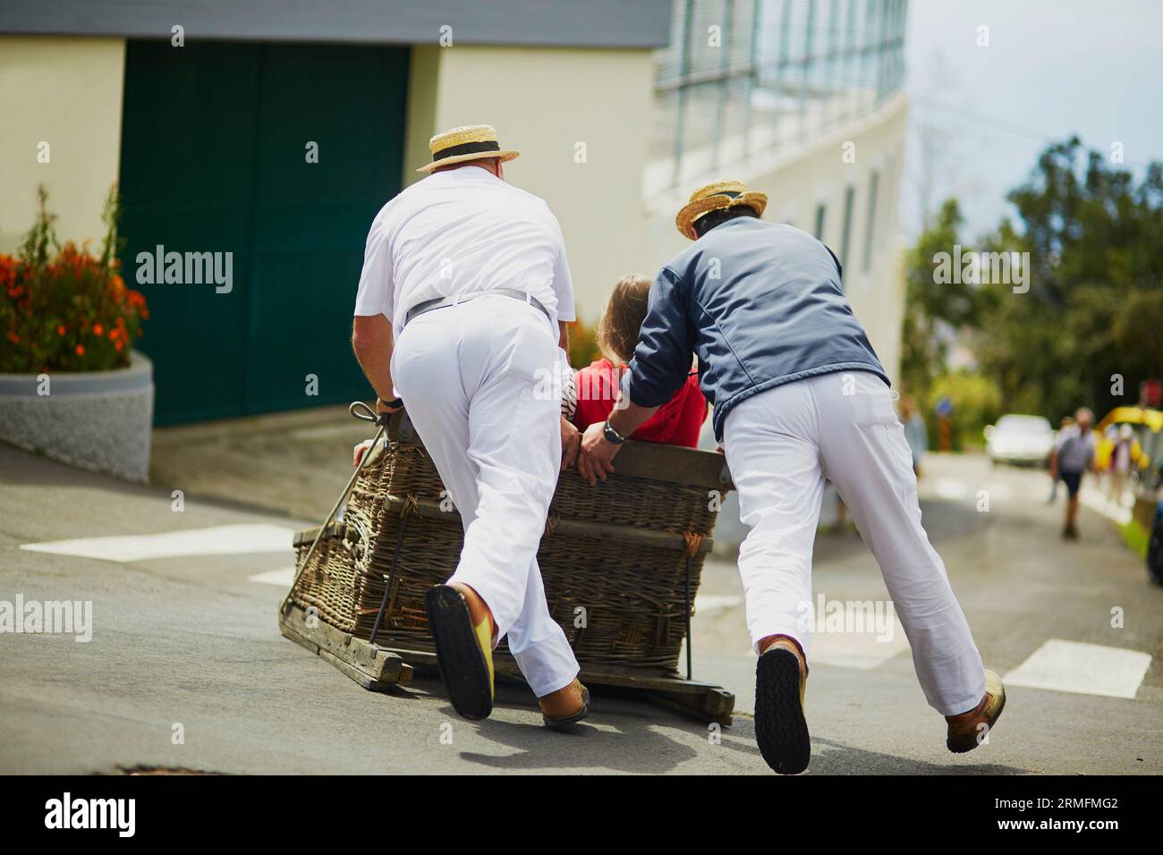 Famous toboggan riders moving traditional cane sledge downhill on the ...