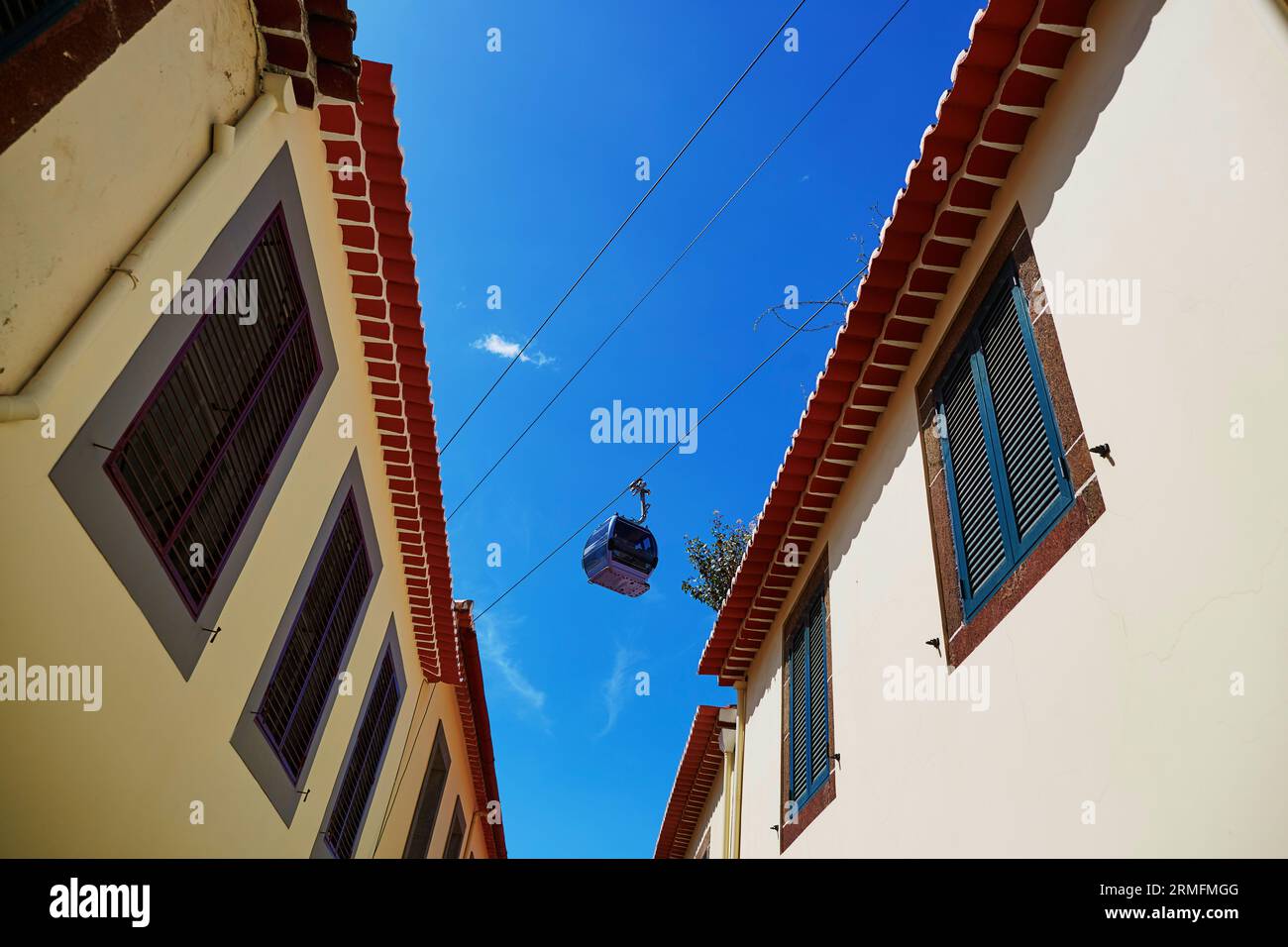Cable ropeway cabin over the roofs of buildings in Funchal, Madeira ...