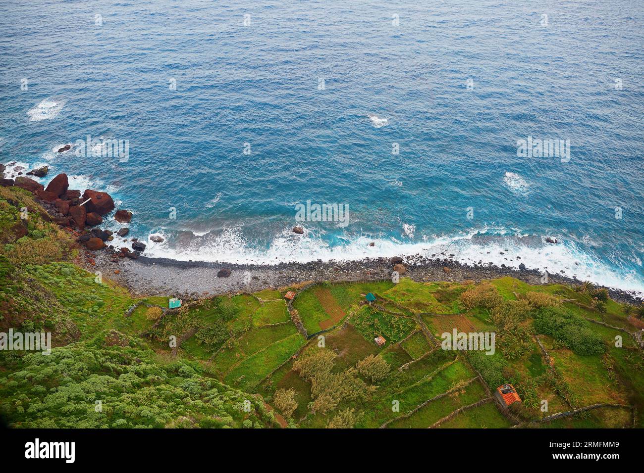 Aerial view of terrace fields and huts on the Northern Atlantic ocean ...