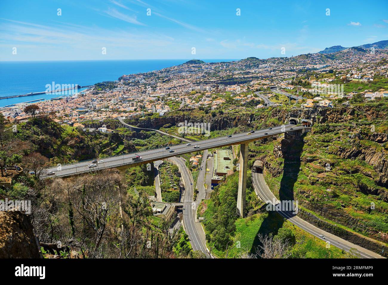 Aerial scenic view of Funchal and large motorway with Atlantic ocean ...