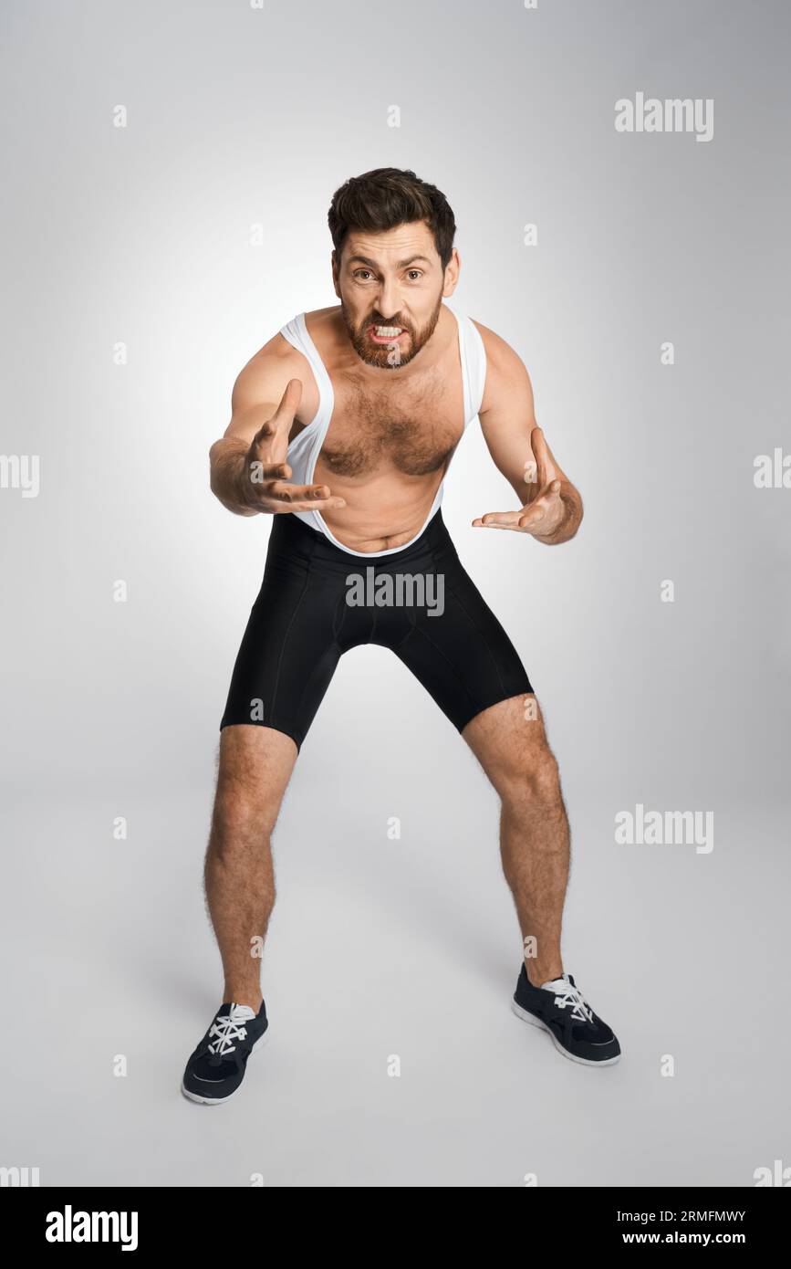 Young wrestler in black and white tight singlet getting ready to attack ...