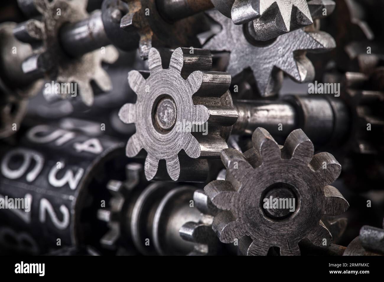 Metal gears and cogs mechanism with numbers Stock Photo - Alamy