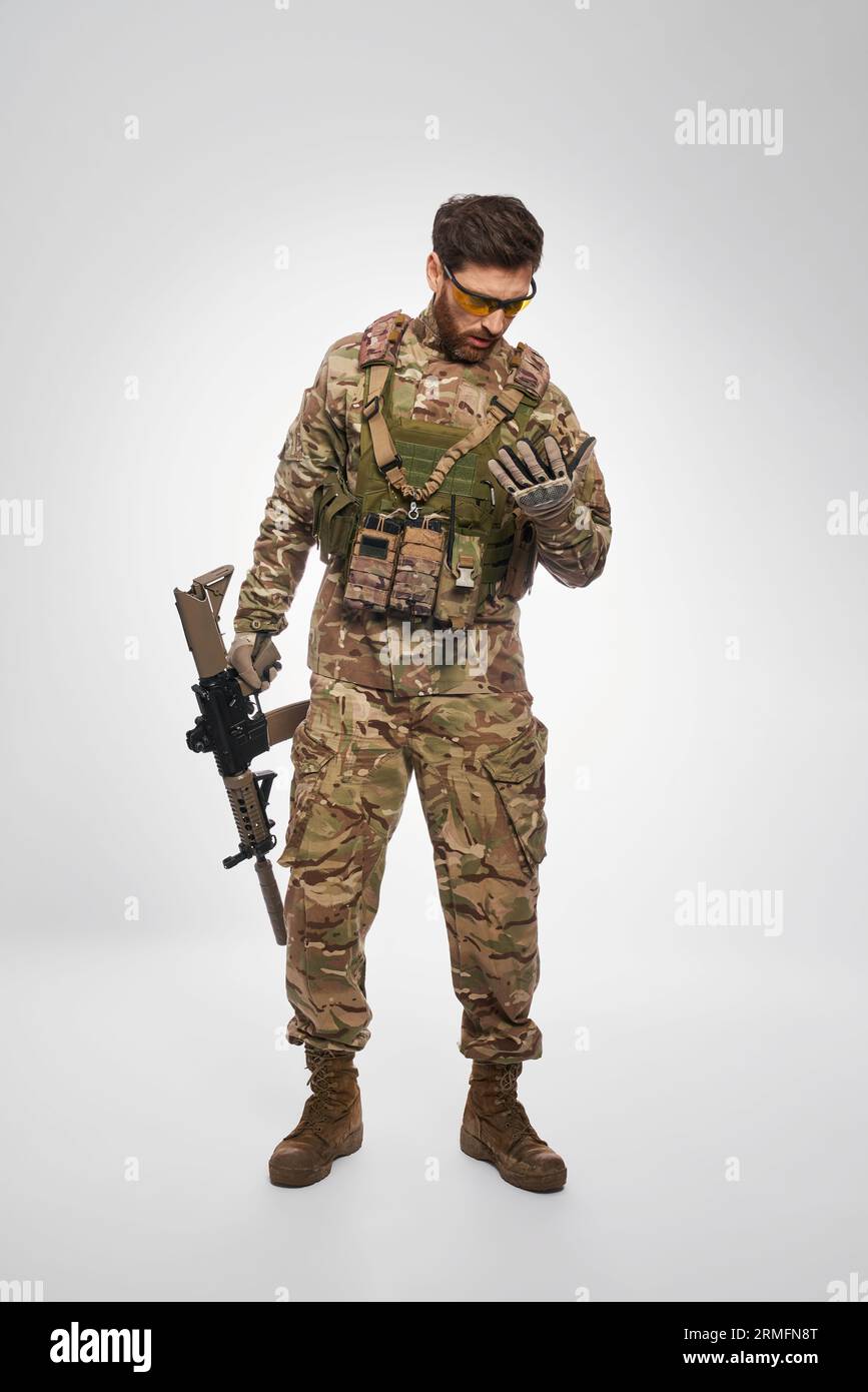 Wounded military infantry in body armor checking chest, if there any ...